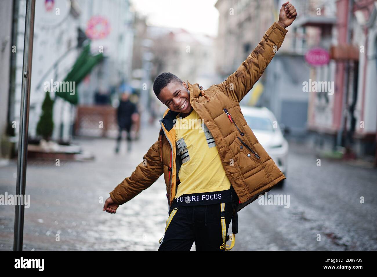 I am so happy! African man wear on jacket at cold weather posed outdoor ...