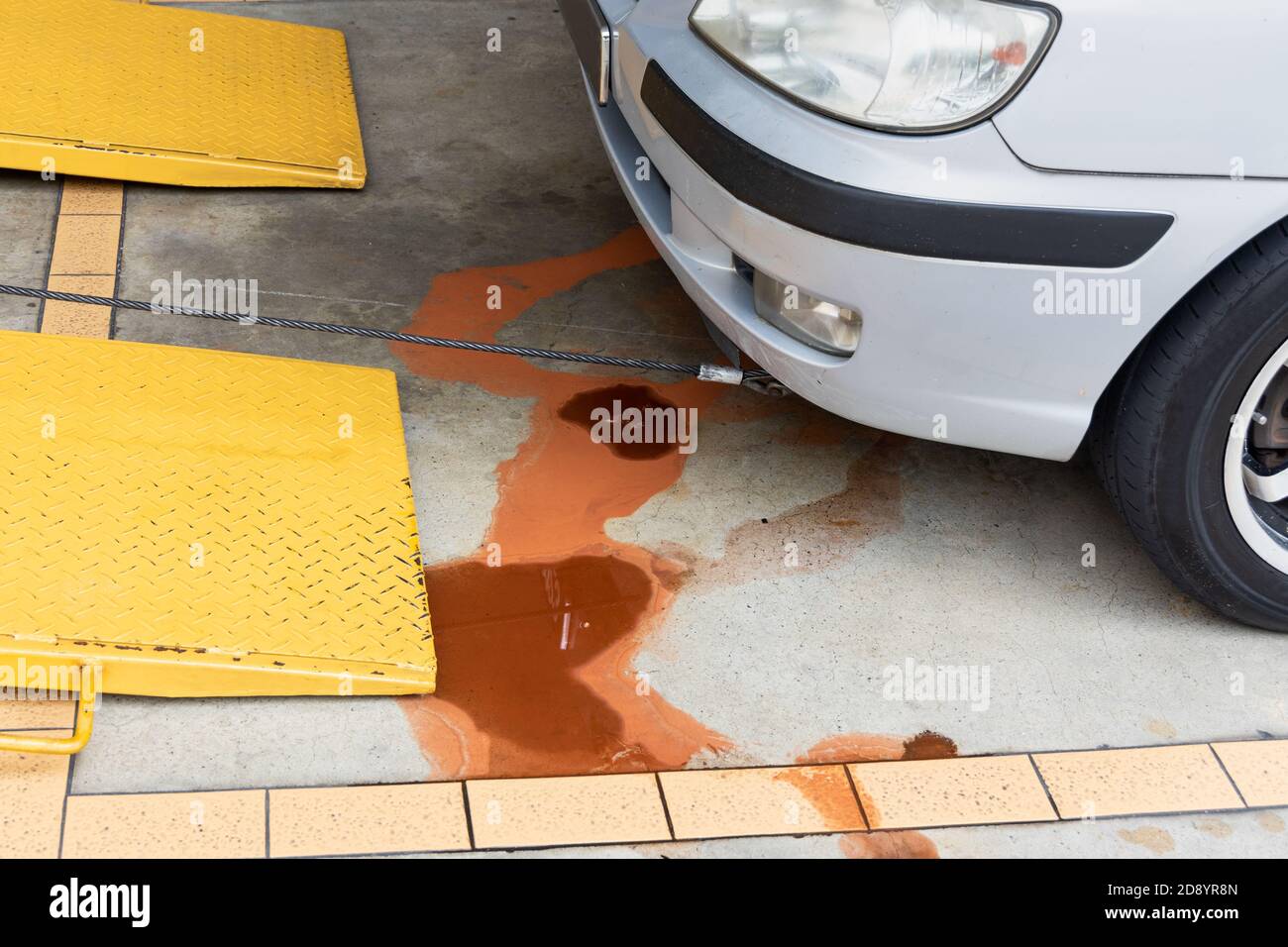 Closeup on car towed onto flatbed tow truck with cable Stock Photo - Alamy
