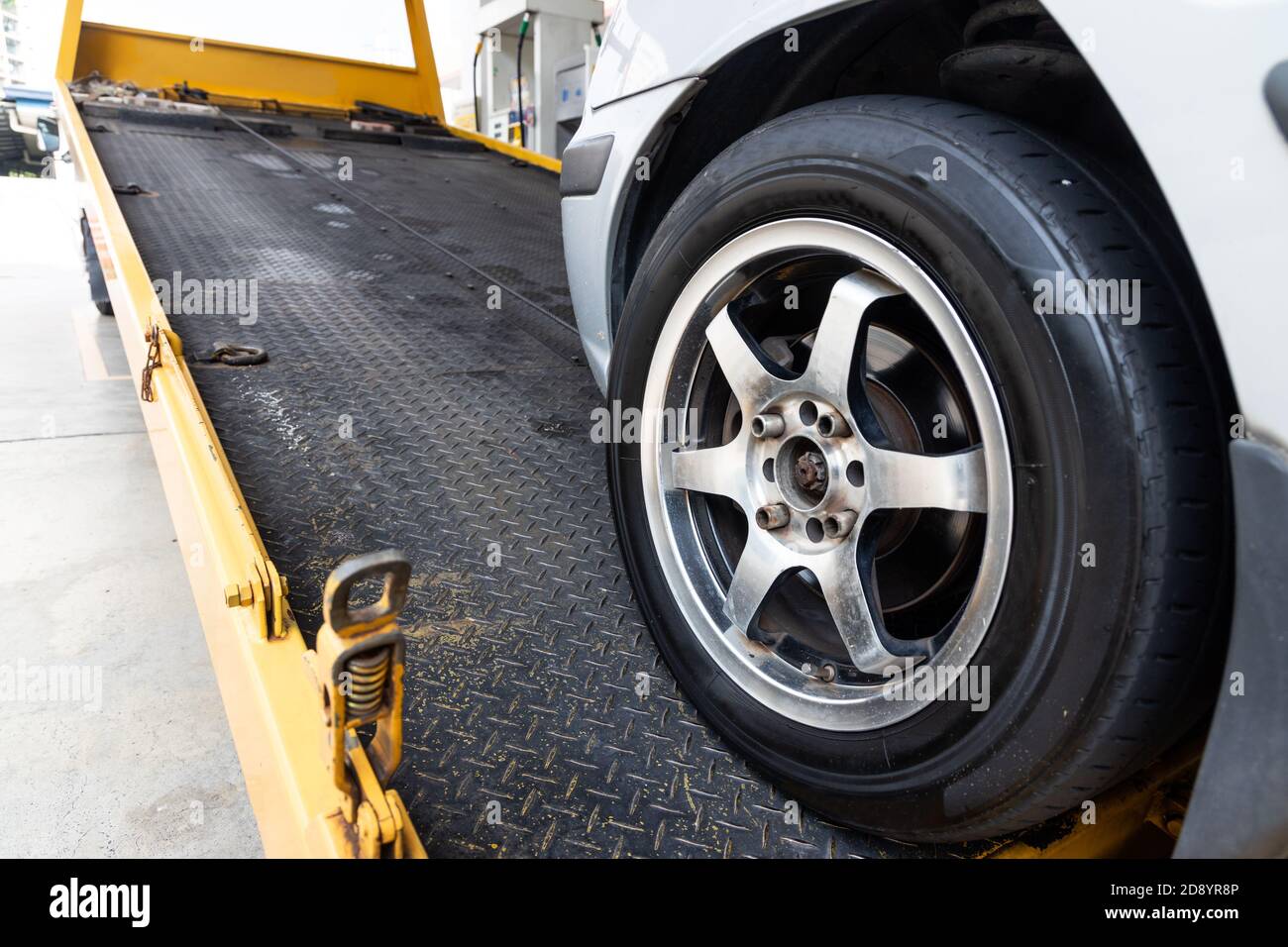 Closeup on car towed onto flatbed tow truck with cable Stock Photo - Alamy