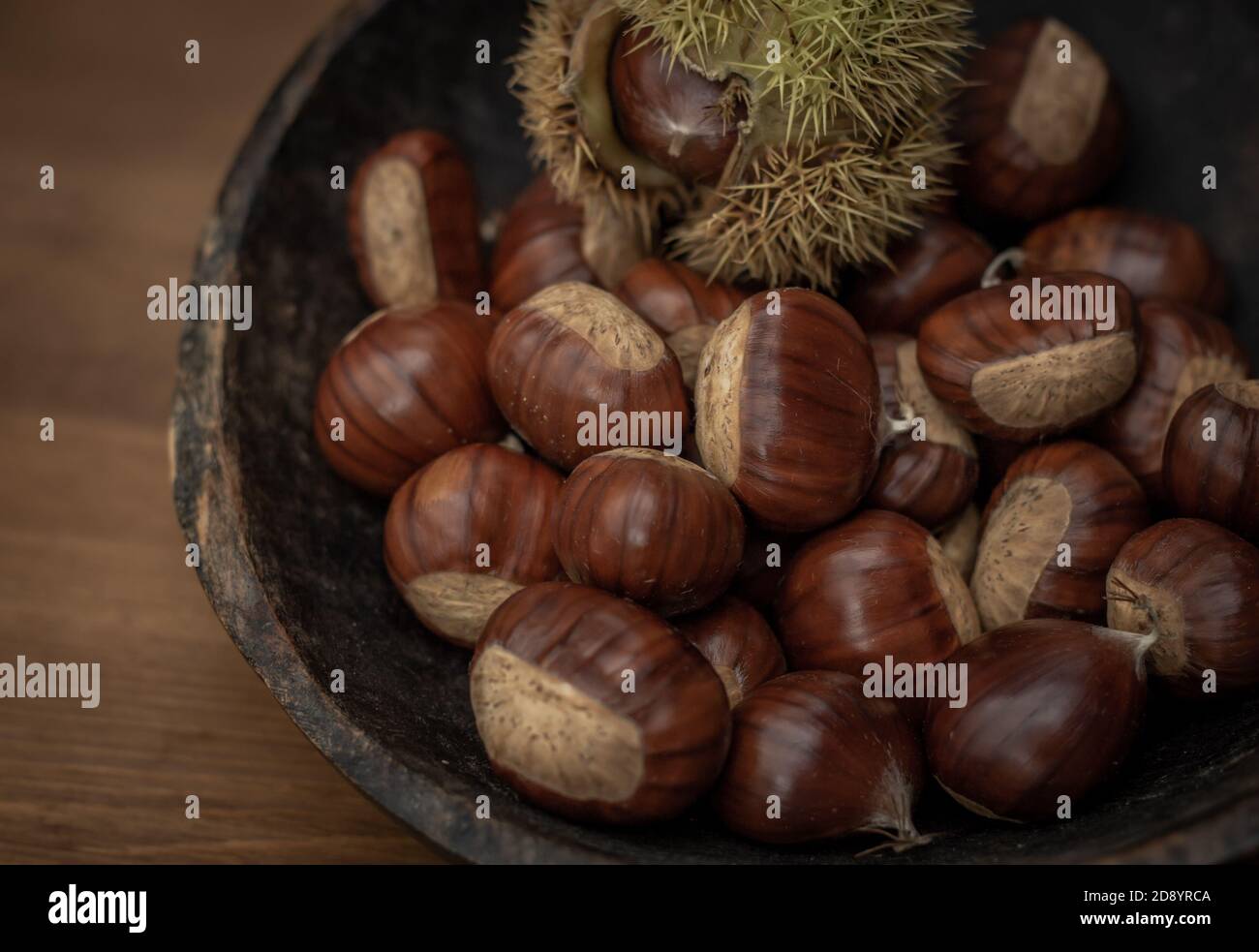 sweet chestnuts rustic composition with opened cupula on daylight ...