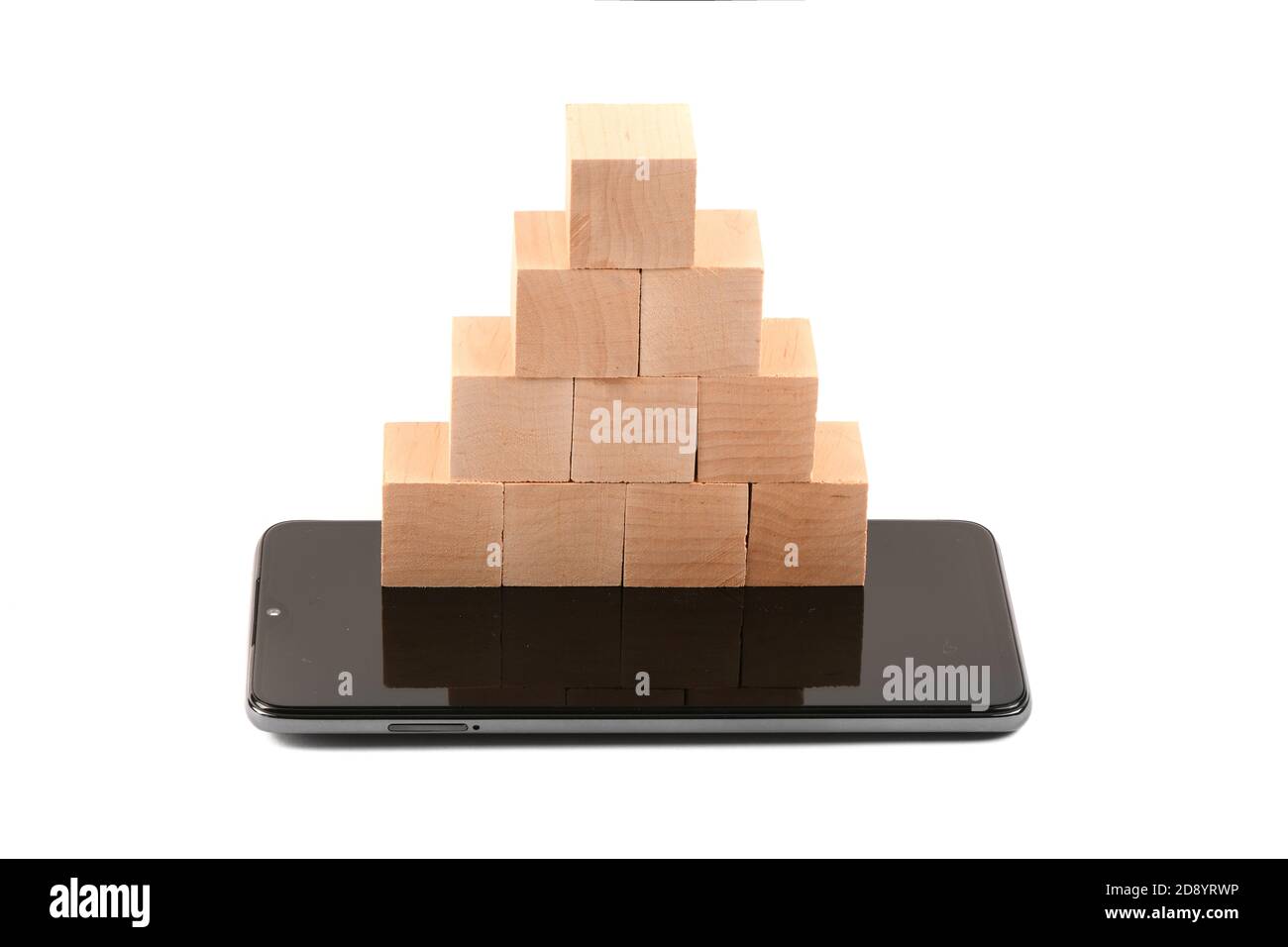 Piramid of wooden cubes on black mobile smartphone. Smartphone with ...