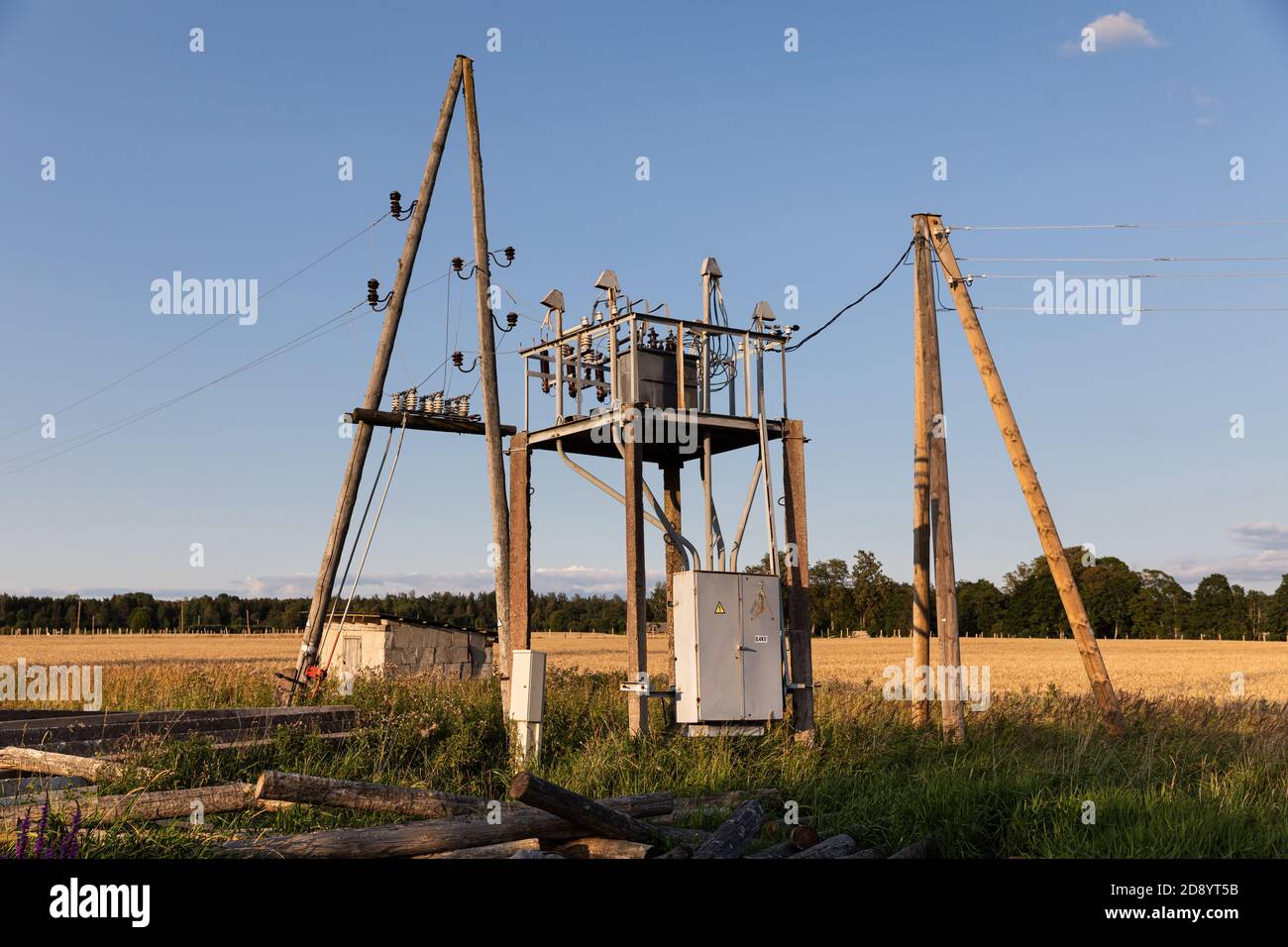 Electrical post by the road with power line cables and transformers ...