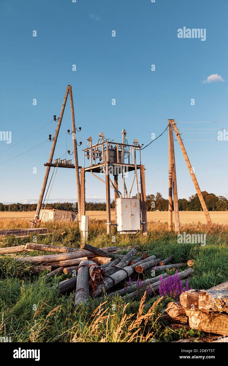 Electrical post by the road with power line cables and transformers ...