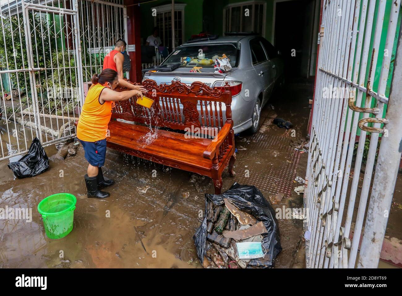 Batangas Province, Philippines. 2nd Nov, 2020. Residents clear mud and ...