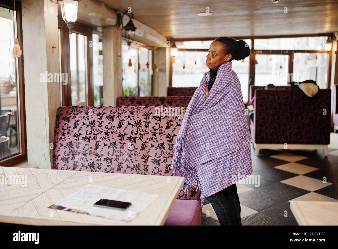 African woman in checkered violet cape posed at cafe Stock Photo - Alamy
