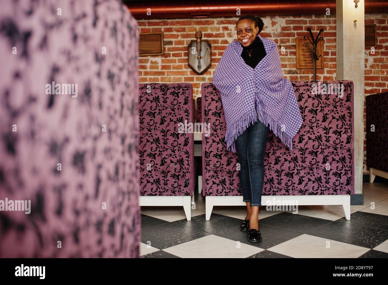 African woman in checkered violet cape posed at cafe Stock Photo - Alamy