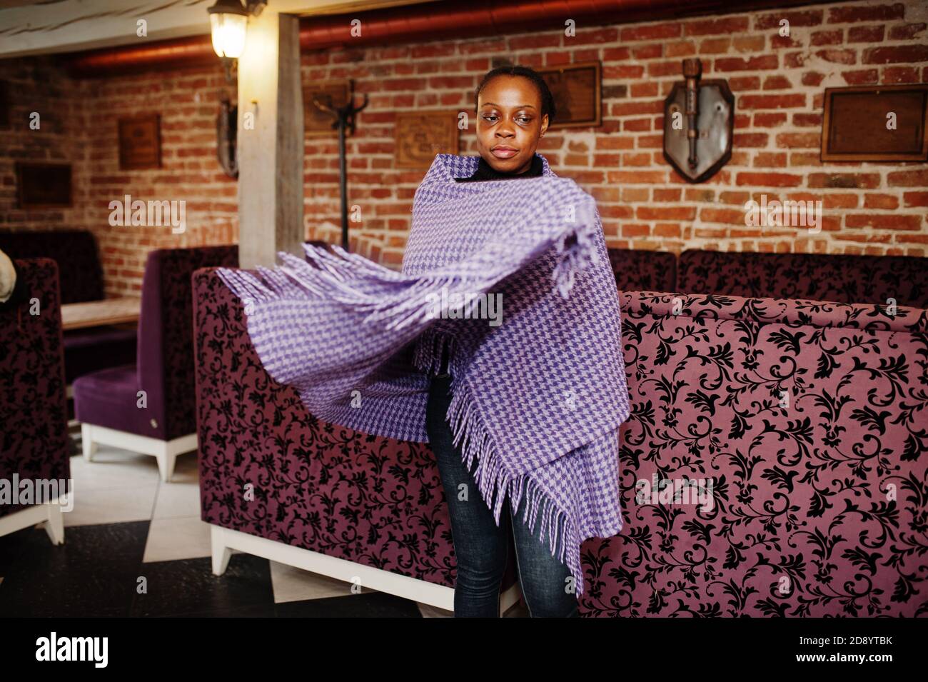 African woman in checkered violet cape posed at cafe Stock Photo - Alamy