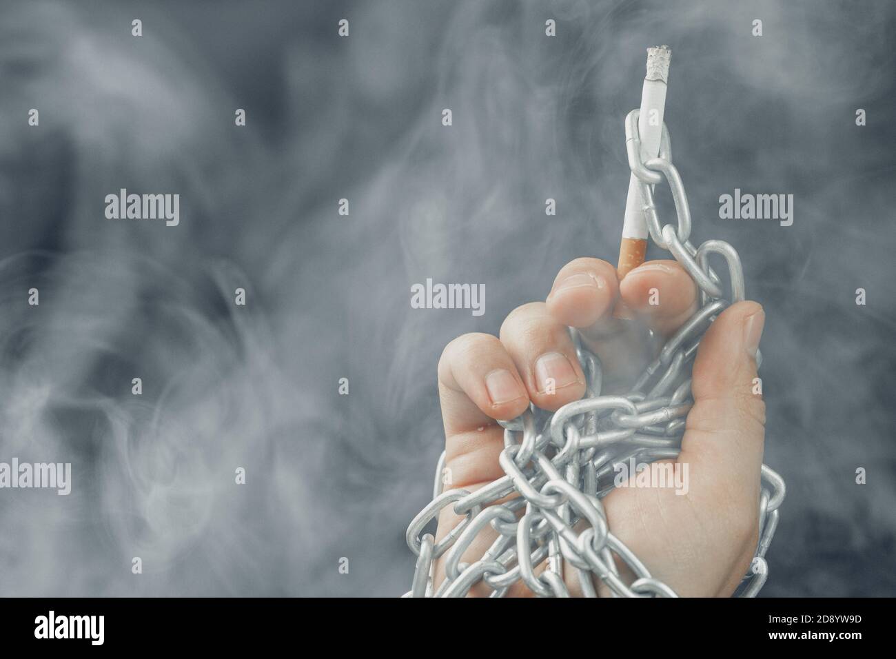 Male hand in metal chains holding cigarette Stock Photo - Alamy