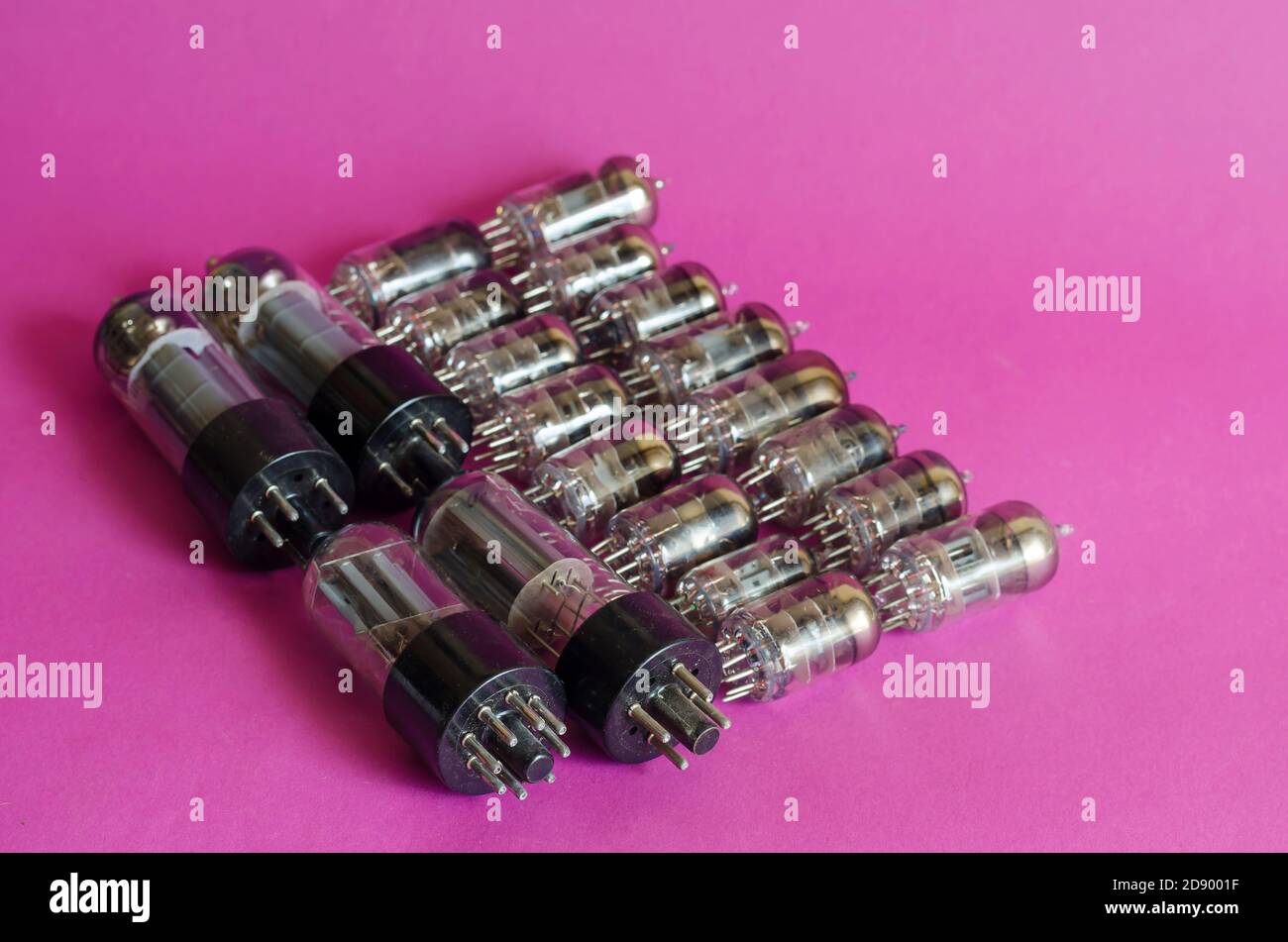 Group of random radio tubes on a pink background. Vacuum tubes of ...