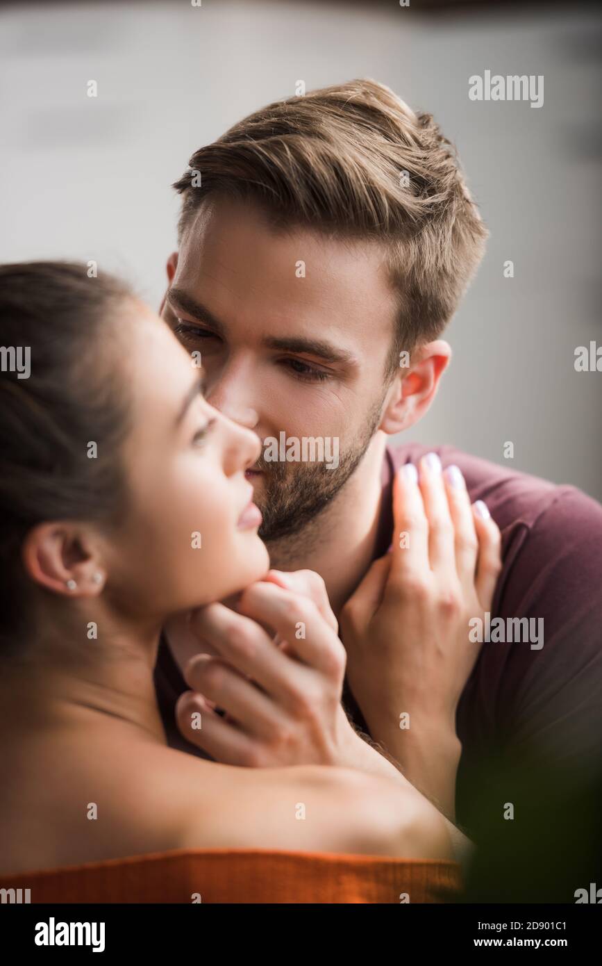tender man touching face of beloved woman on blurred foreground Stock ...