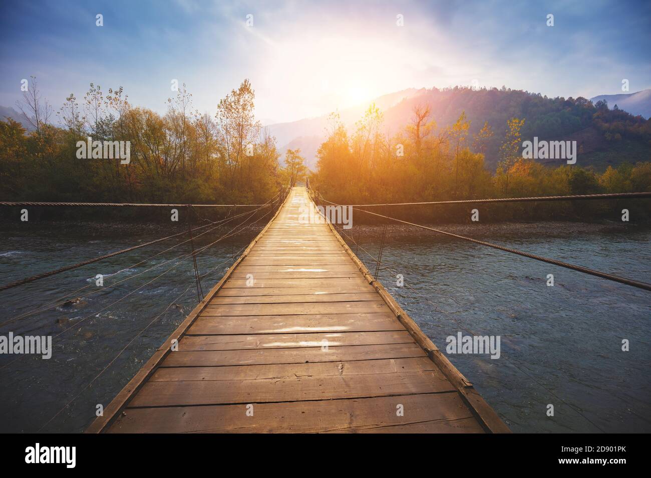 Hanging rope wooden bridge over mountain river Stock Photo - Alamy