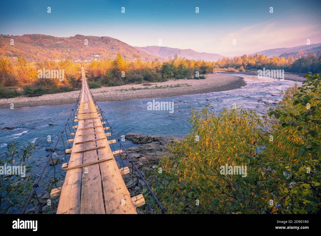 Hanging rope wooden bridge over mountain river Stock Photo - Alamy