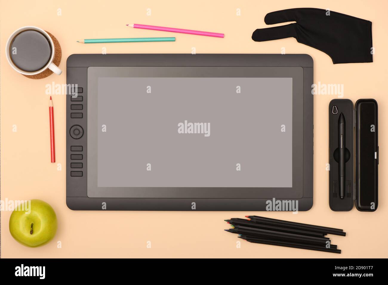 Graphic monitor stylus on peachy color table. Black tablet computer ...