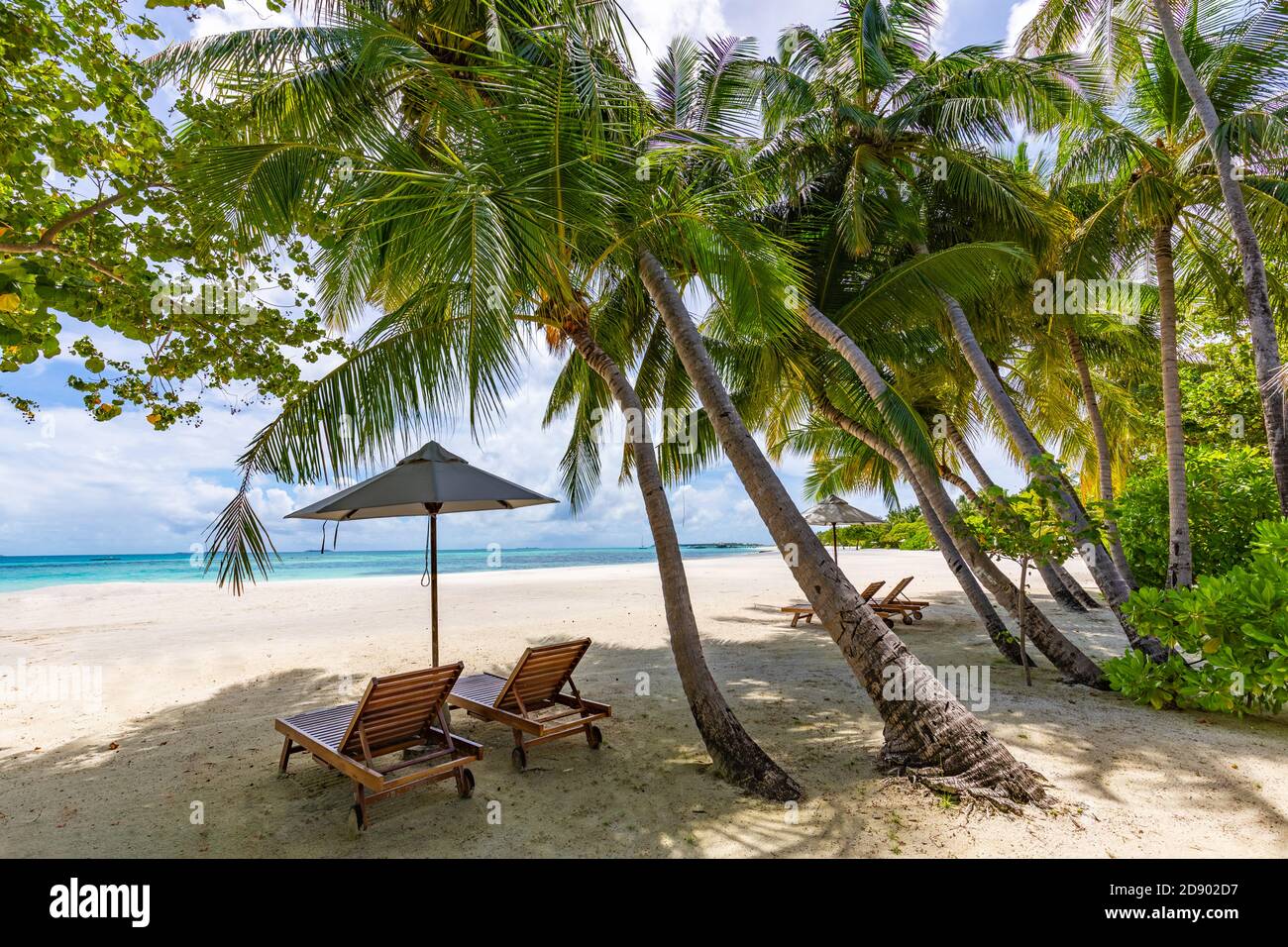 Two beach chairs on idyllic tropical white sand beach. Shadow from the ...