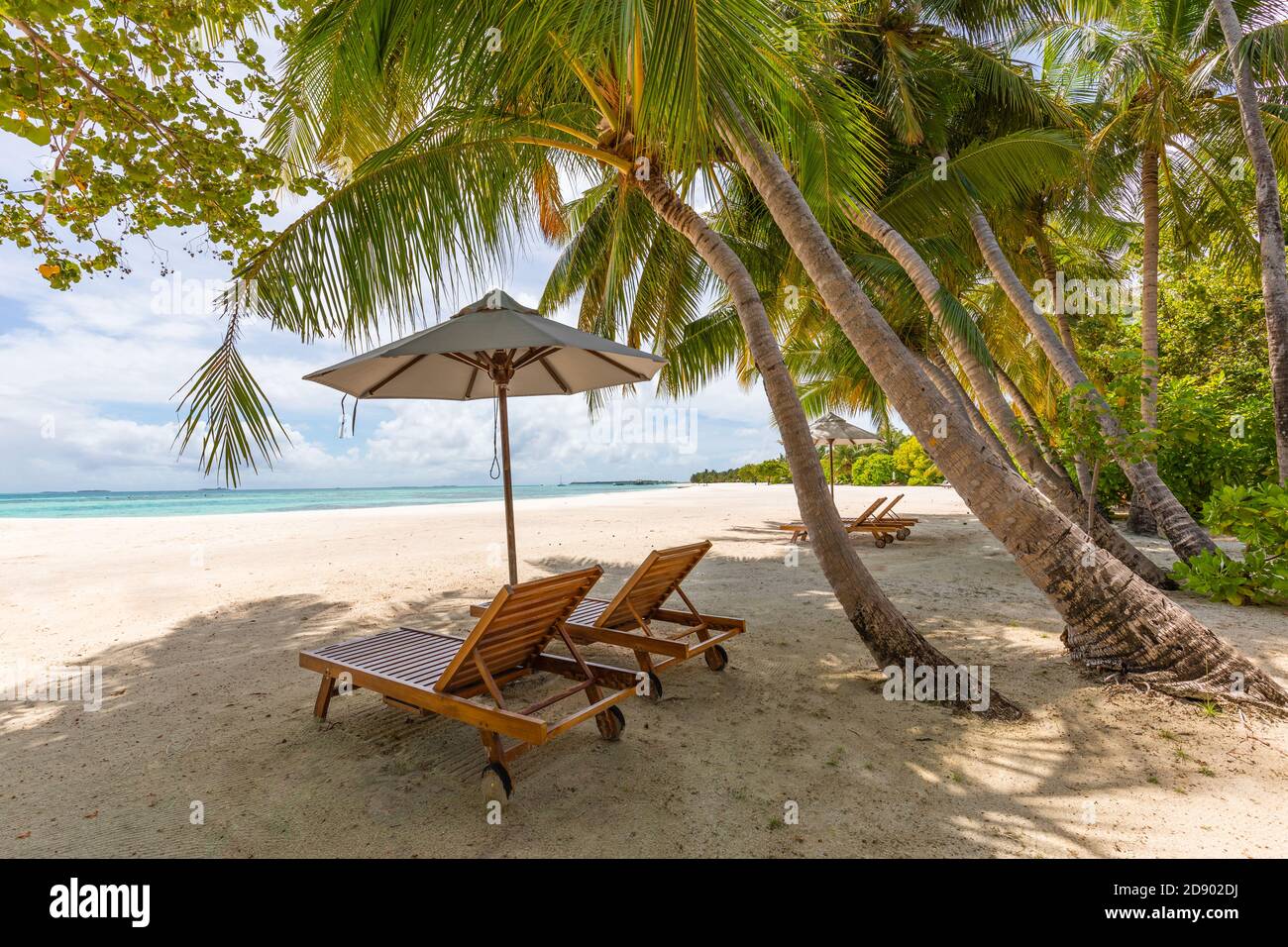 Two beach chairs on idyllic tropical white sand beach. Shadow from the ...