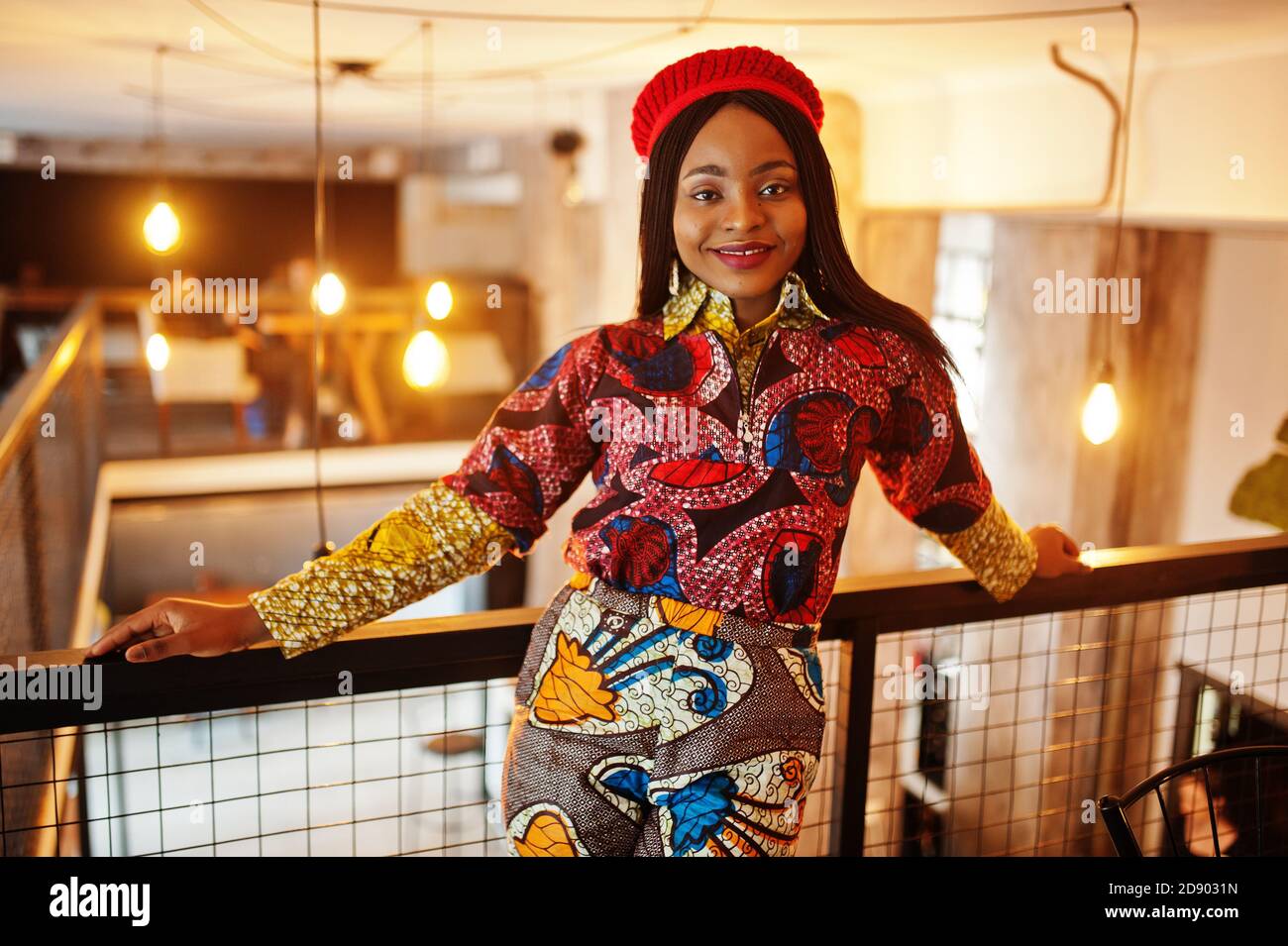 Enthusiastic african american woman in trendy coloured outfit with red ...