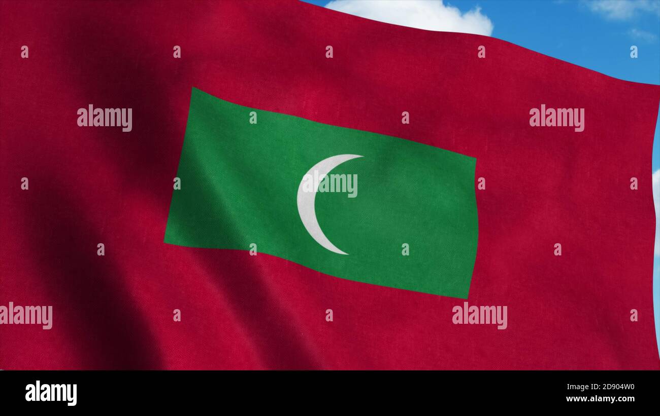 Republic of Maldives flag on a flagpole waving in the wind, blue sky ...