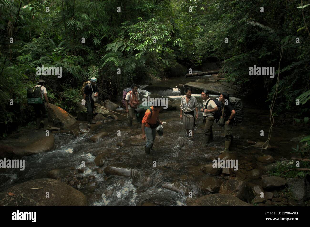 A team of conservation workers taking a pause on a small river on the ...