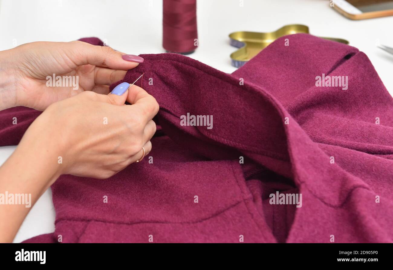 Dressmaker sews clothes to order, making clothes Stock Photo - Alamy