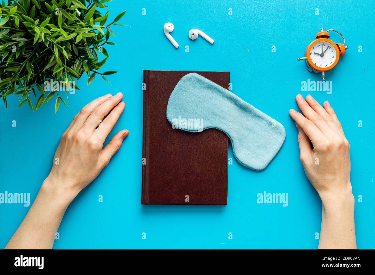 Reading book before going to bed. Sleeping accessories on the table ...