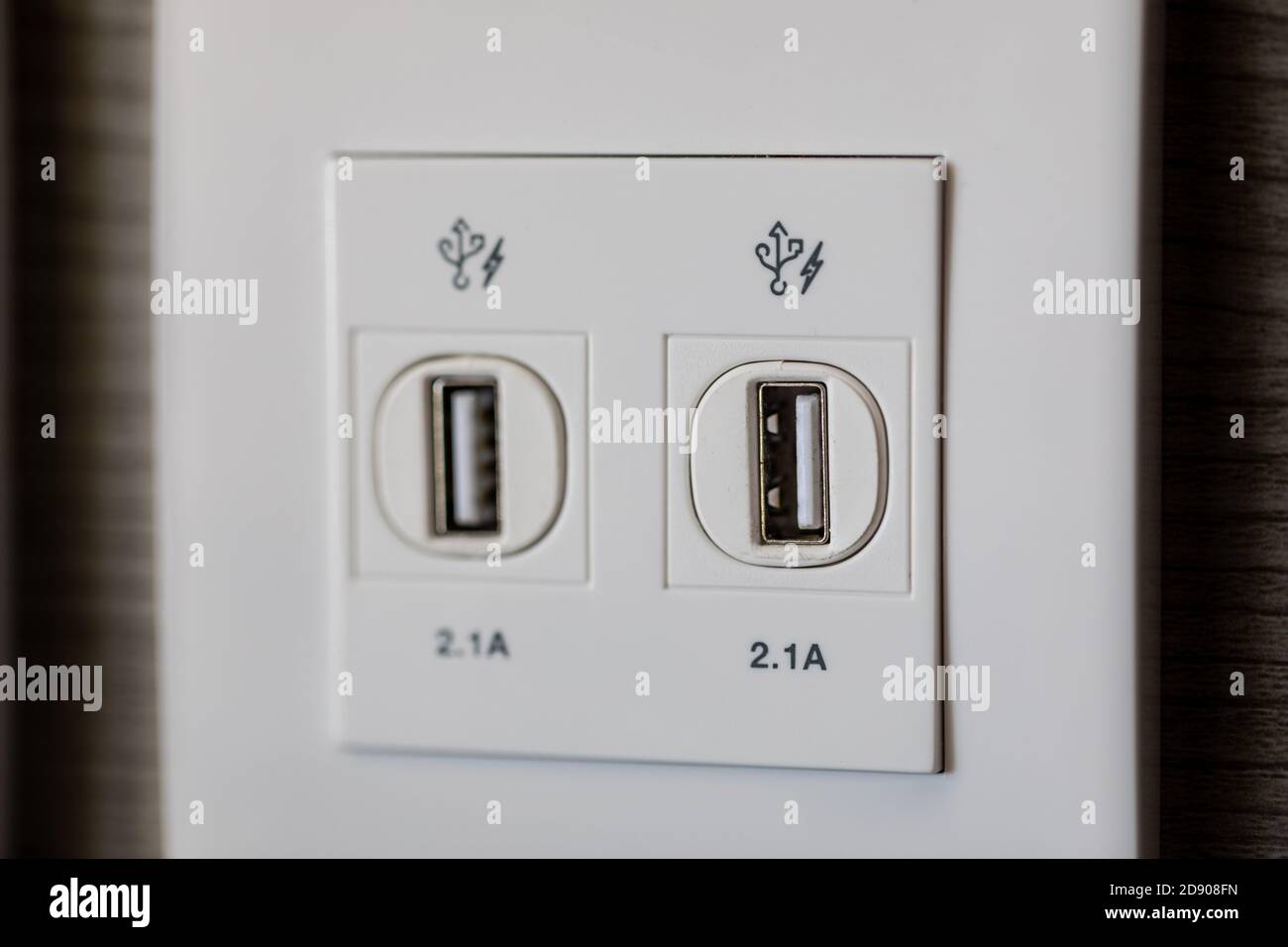 USB plug for charging power of all devices at the wooden wall. USB slot ...