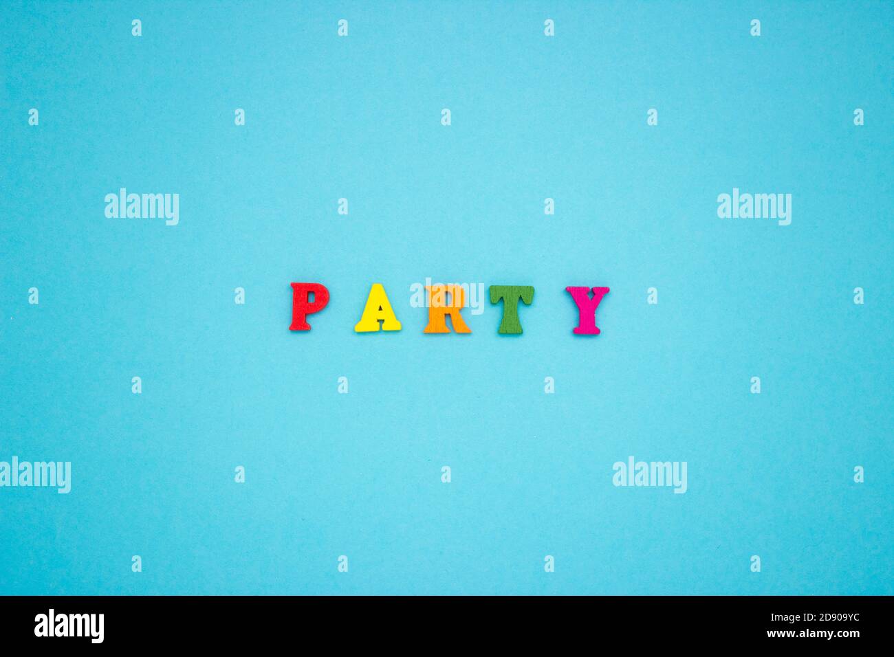 The word PARTY on a blue background of wooden multicolored letters ...