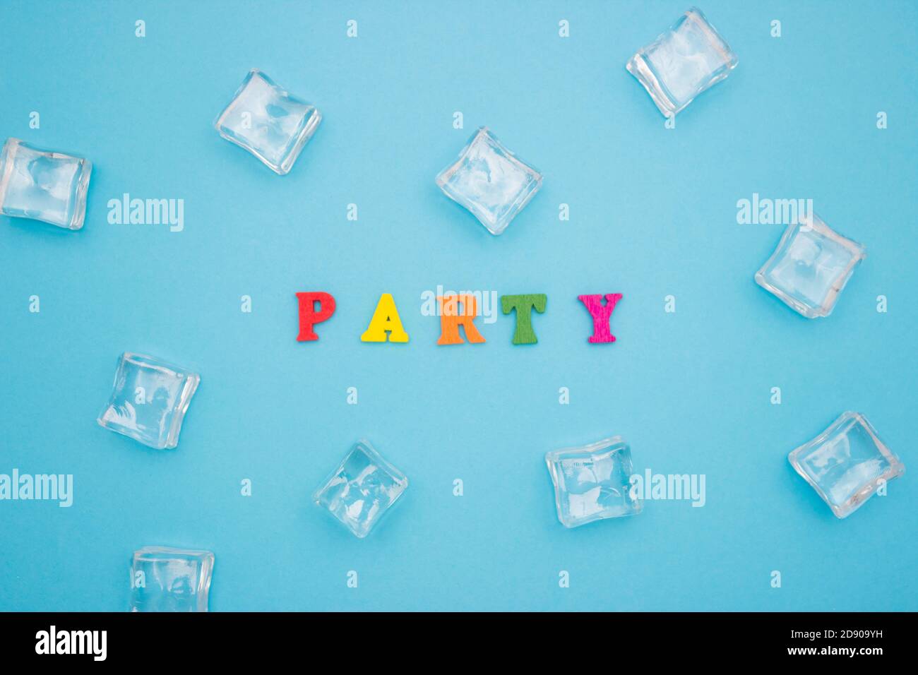 Word PARTY on a blue background of wooden multicolored letters, ice ...