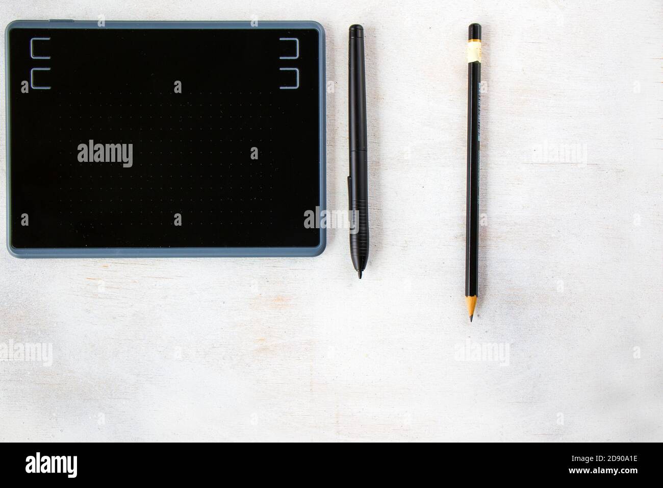Drawing and painting tablet and styles pen and pencils on the white ...
