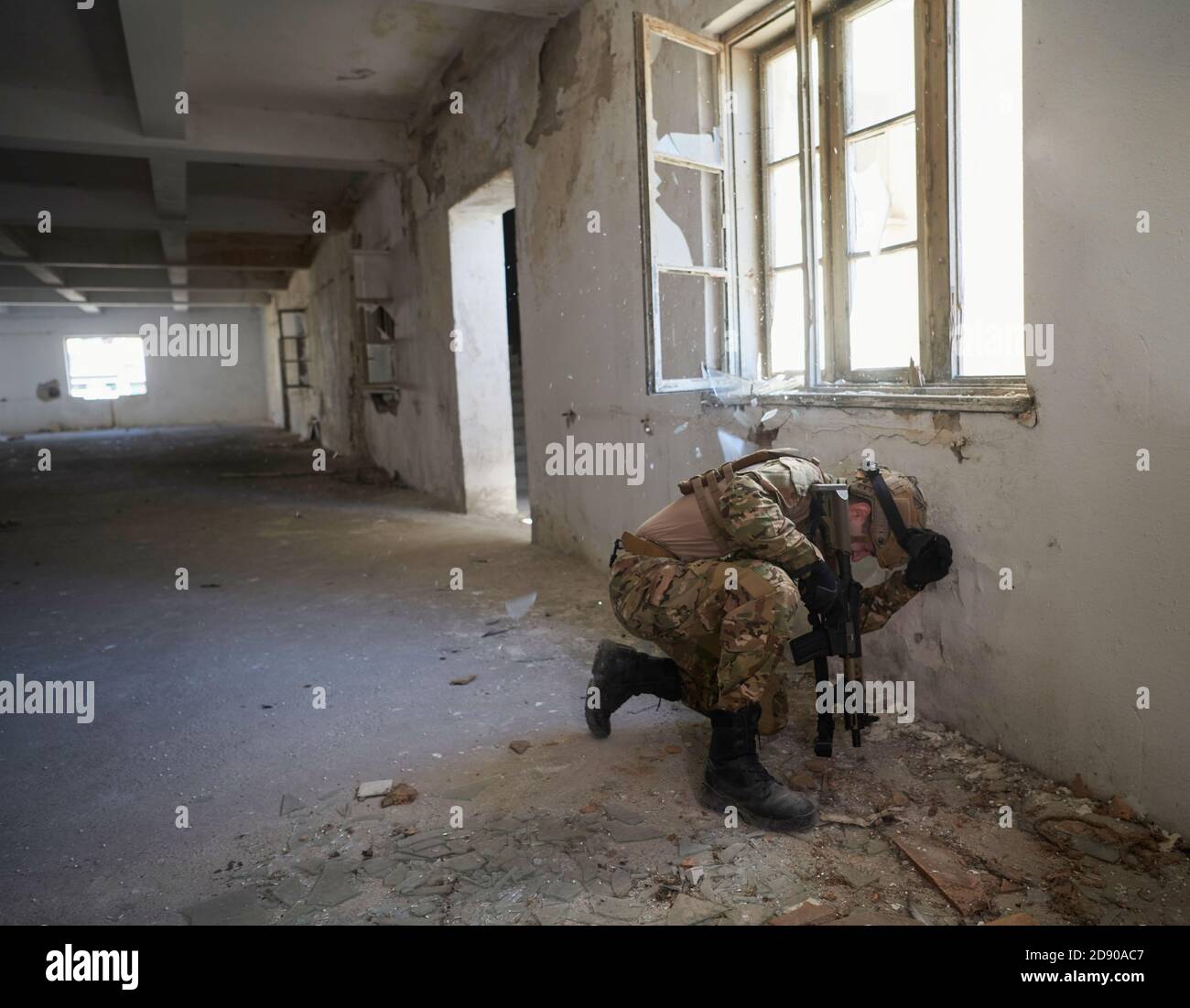 soldier in action near window changing magazine and take cover Stock ...