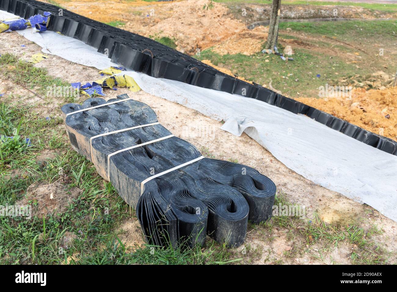 Slope erosion control grids, sheets and earth on steep slope Stock ...