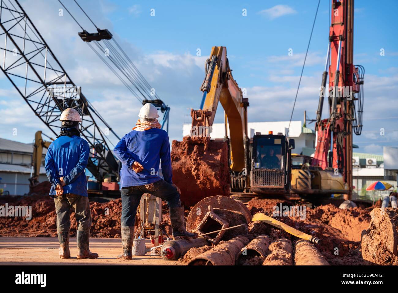 workers with excavator drilling truck in construction site Stock Photo ...