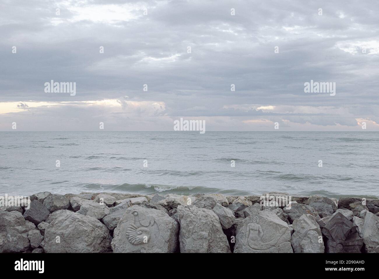 Rainy sky with a lot of grey clouds on a rocky beach, in the north of ...