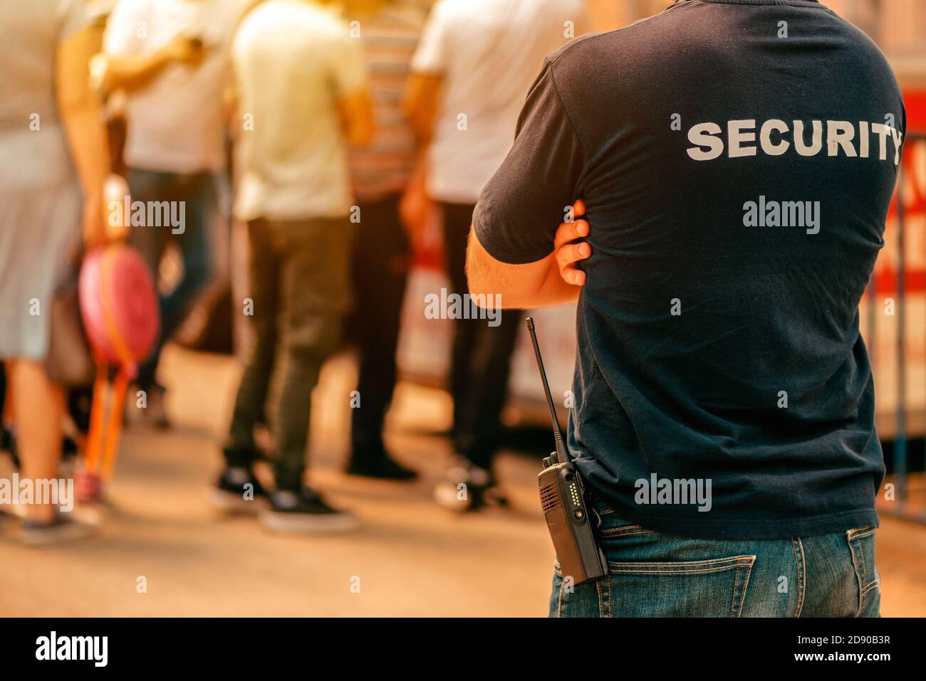 Security guard at live festivale event standing in front of the crowd ...