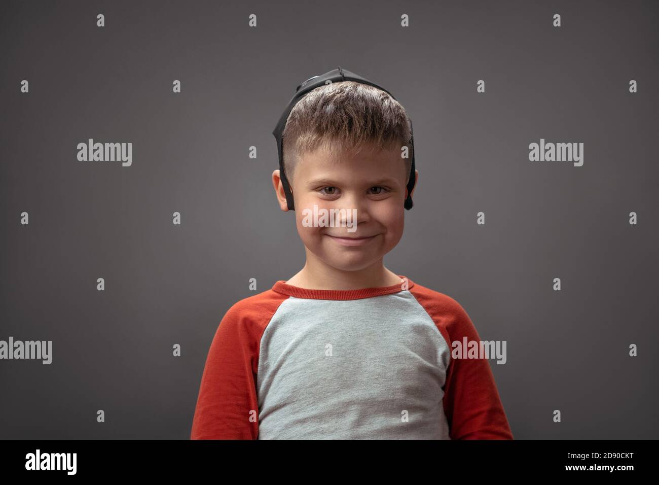 Smiling Caucasian boy with face mask wearing at his head. Happy Little ...