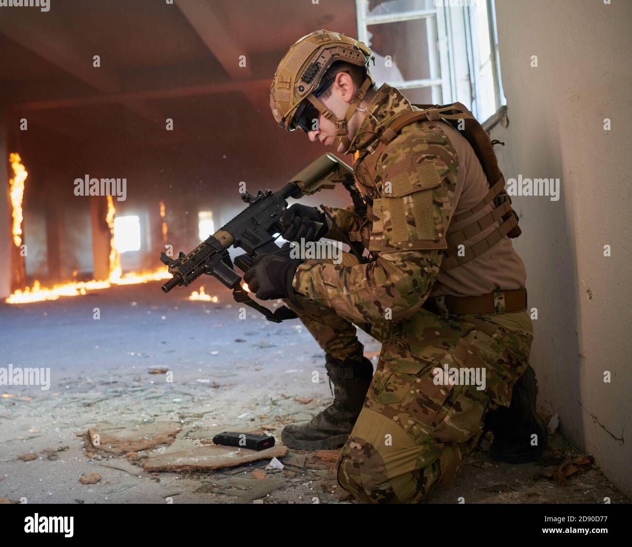 soldier in action near window changing magazine and take cover Stock ...