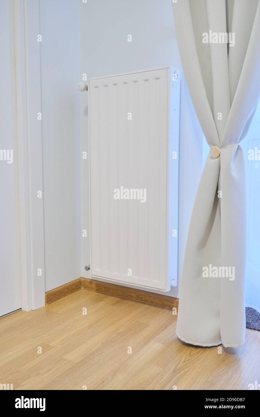 White heating radiator with temperature thermostat in interior of ...