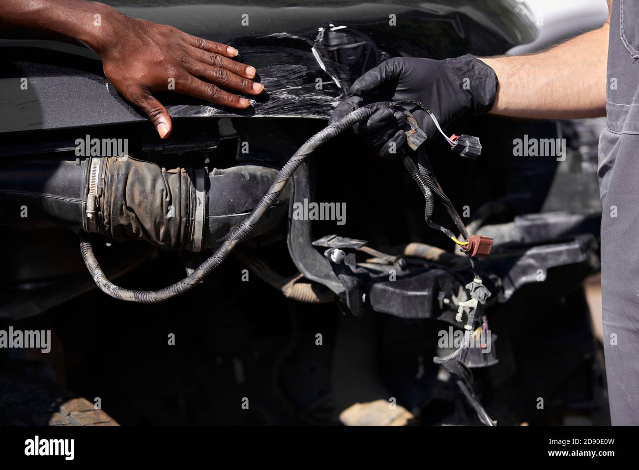 two friendly professional auto mechanic during work, they are ...