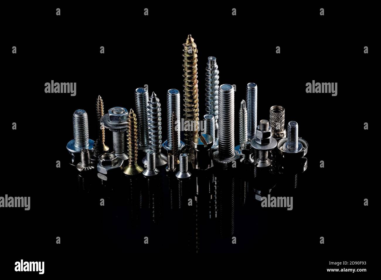 Night city of screws, bolts and nuts with reflection on a black ...