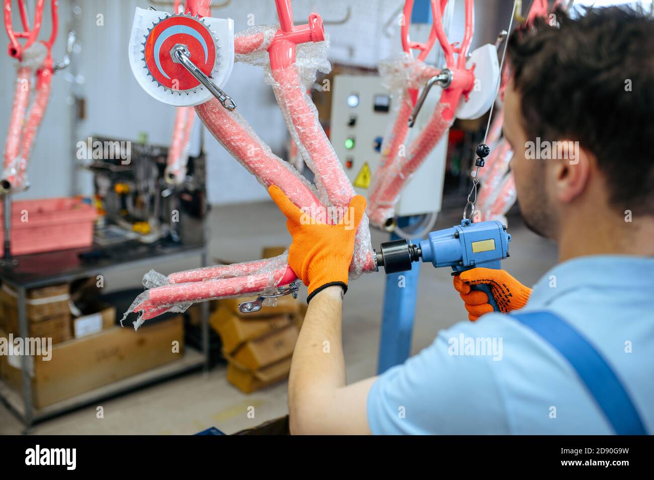 Bicycle factory, worker holds pink kid's bike Stock Photo - Alamy