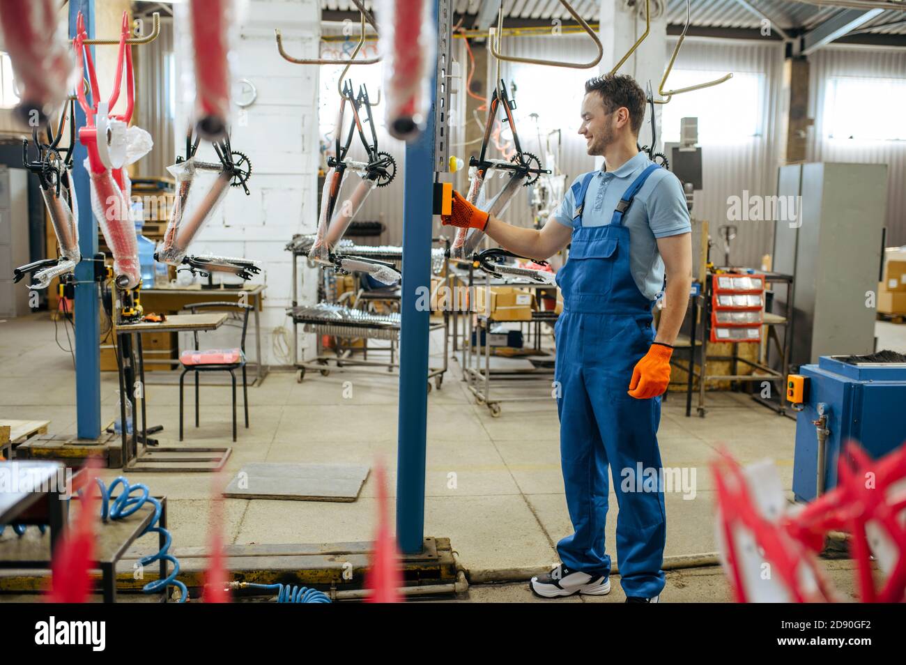 Bicycle factory, worker at bike assembly line Stock Photo - Alamy