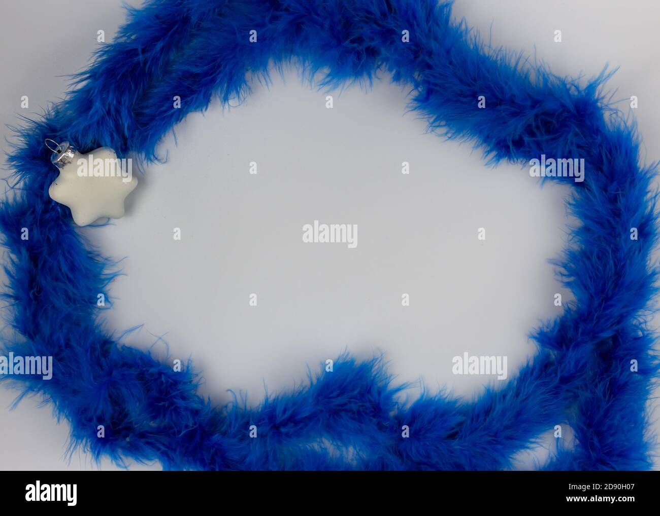 Blue color fluffy frame on white background with white Christmas star ...