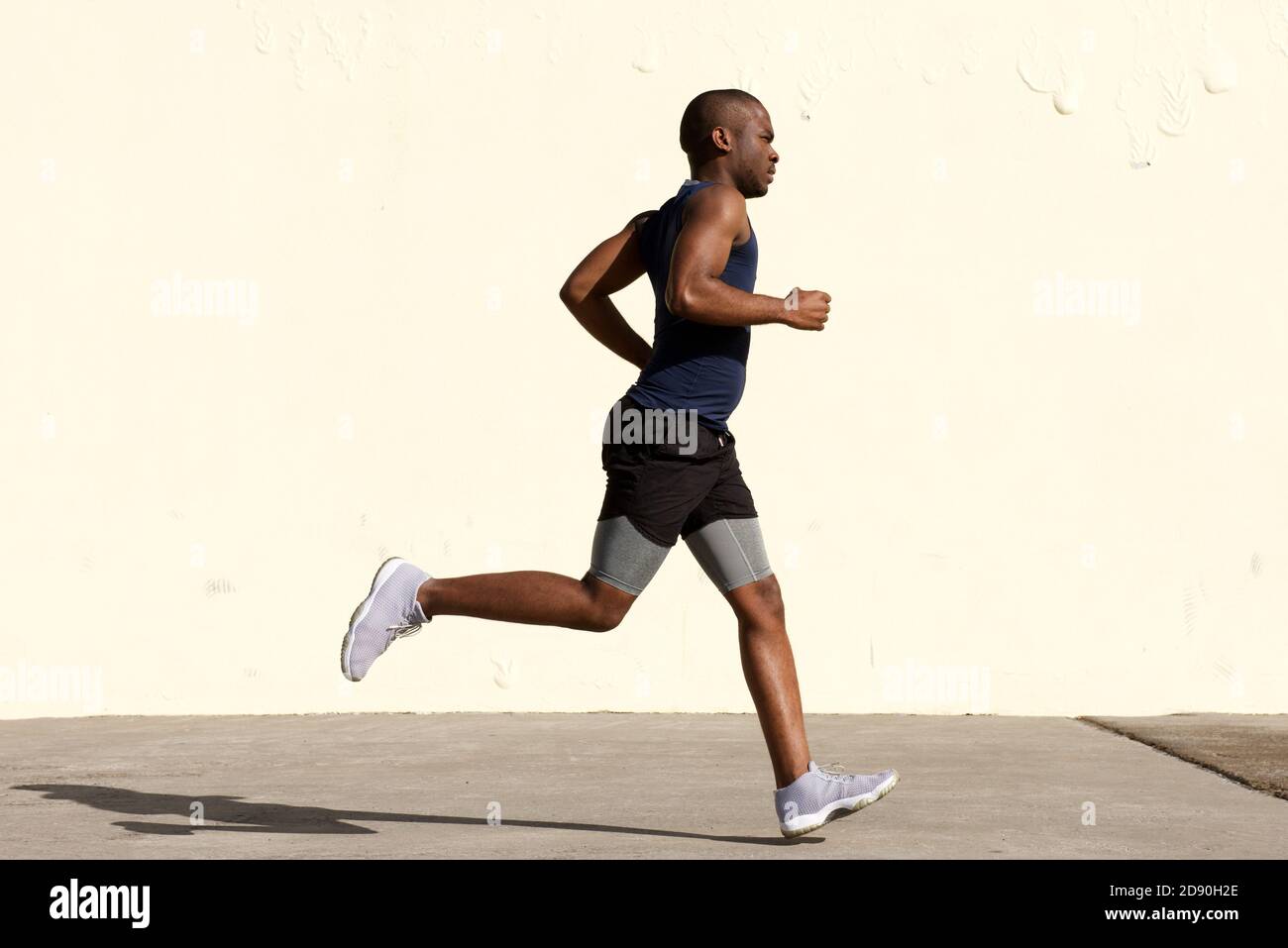 Full body profile portrait of young african american man running by ...