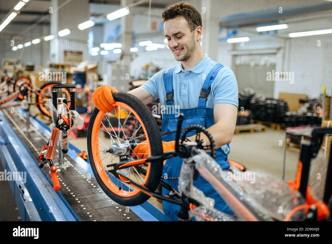 Bicycle factory, assembly line, wheel installation Stock Photo - Alamy