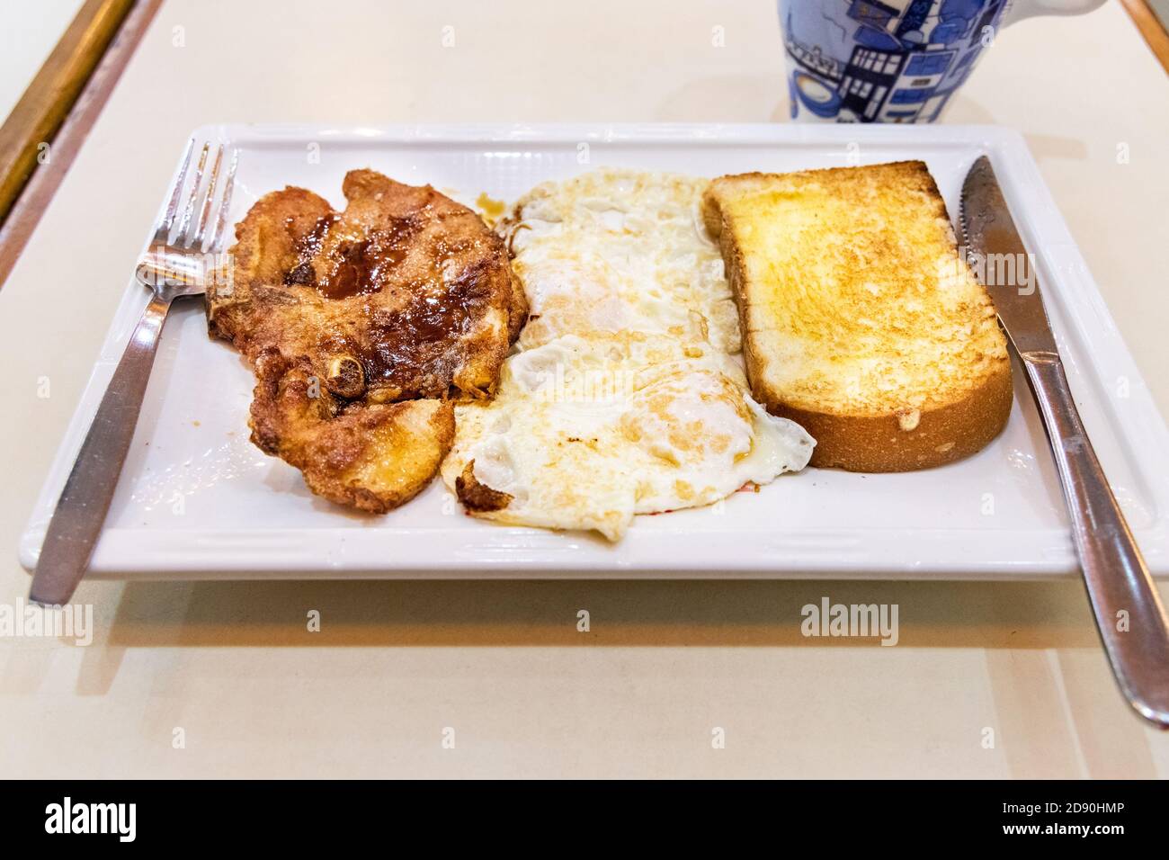 Simple pork chop, fried eggs, bread breakfast in Hong Kong Stock Photo ...