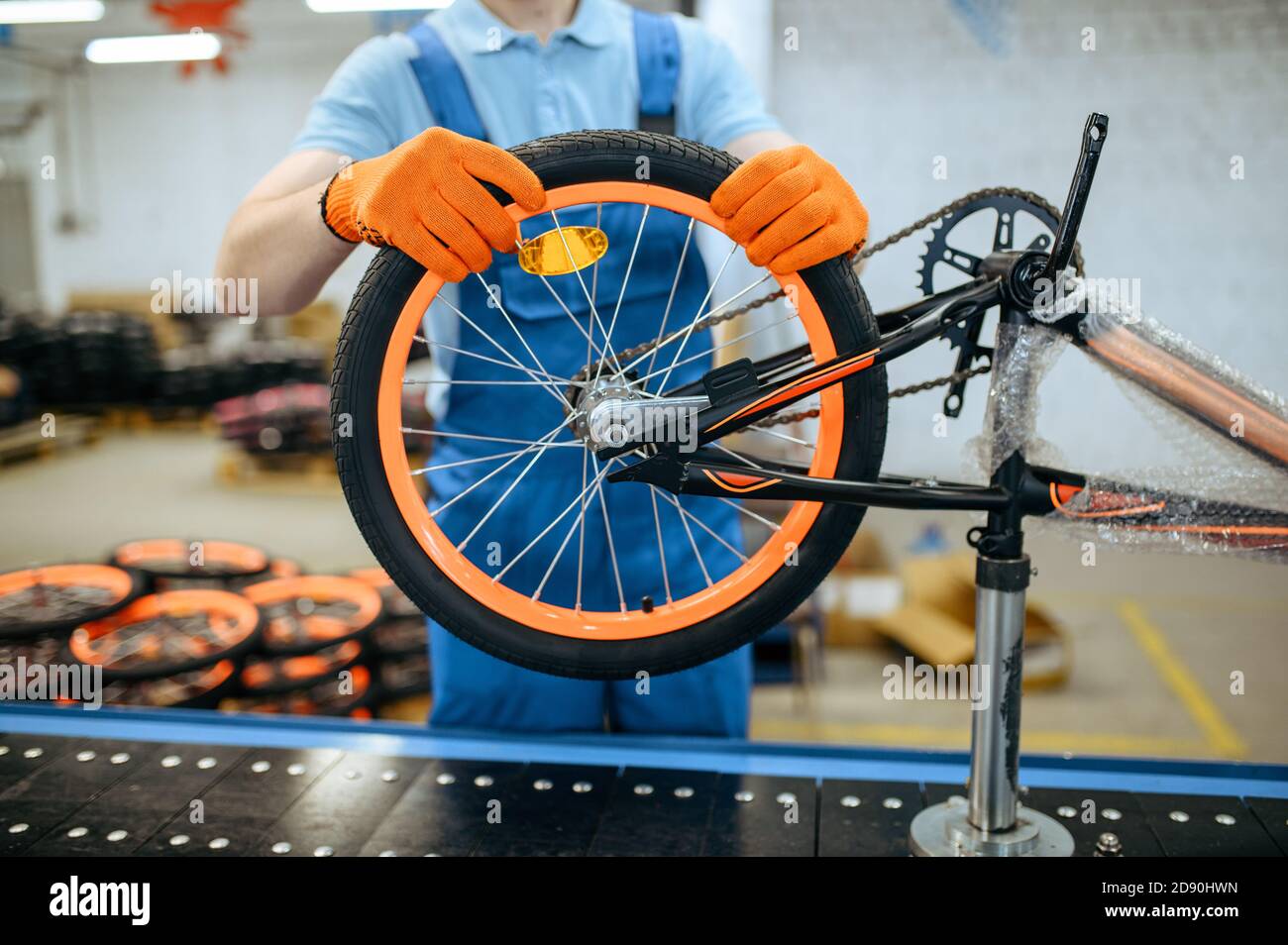 Bicycle factory, assembly line, wheel installation Stock Photo - Alamy