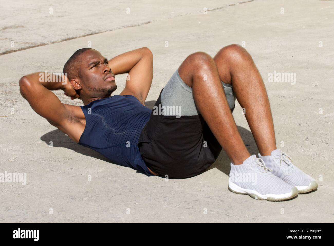 Portrait of healthy young black man doing sit ups outdoors Stock Photo ...
