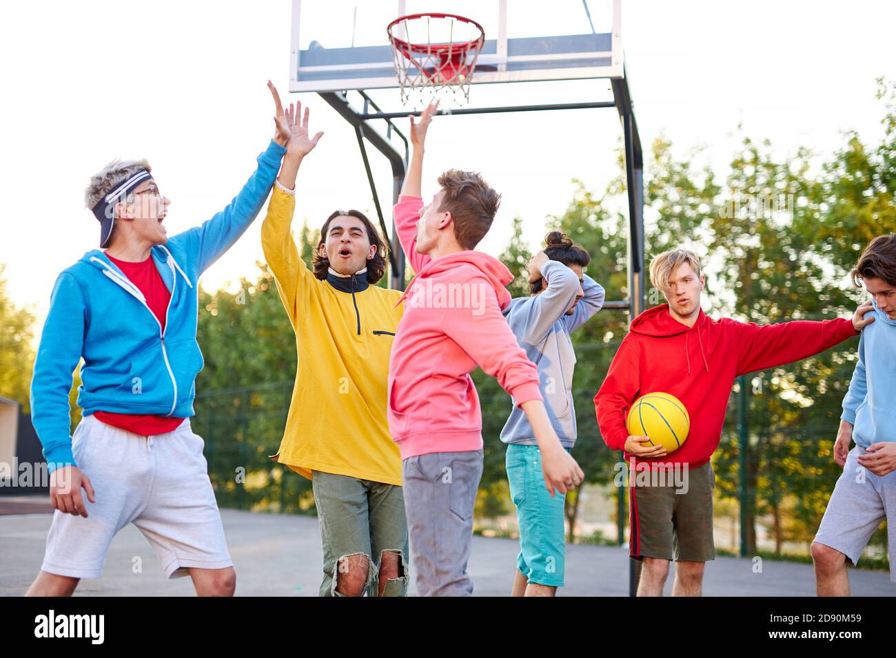 young basketball team give high five to each other, celebrate the win ...