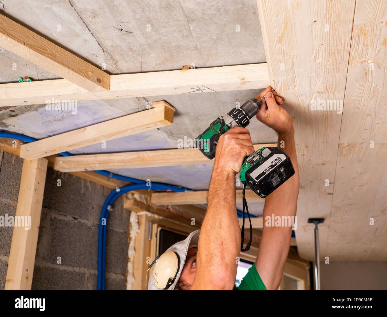 worker screws wooden boards with screwdriver drill Stock Photo - Alamy