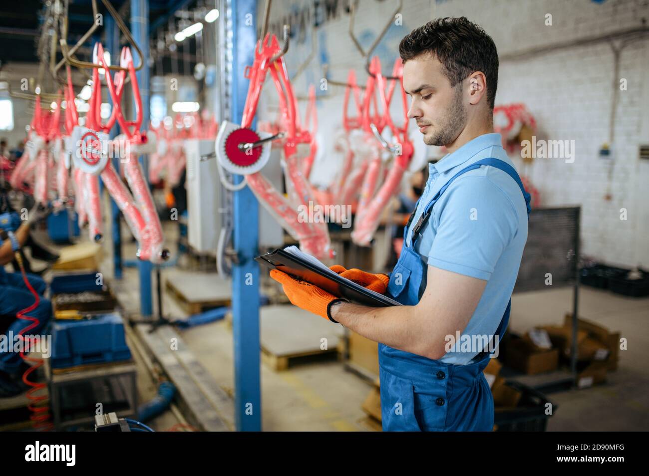 Bicycle factory, man checks bike assembly line Stock Photo - Alamy