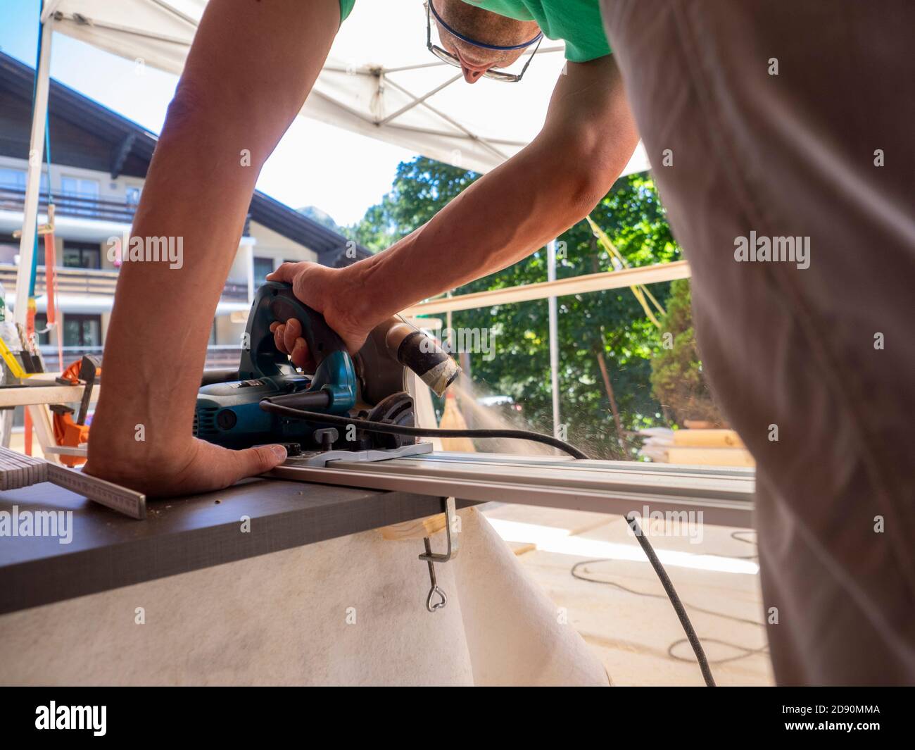 worker cutting strips with machinery Stock Photo - Alamy